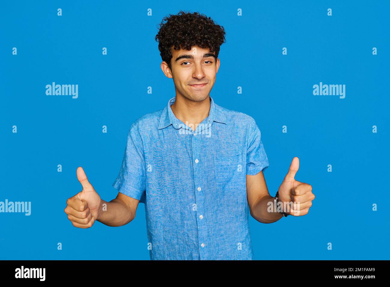 Teenage man smiling because everything has gone well, OK sign, all ...