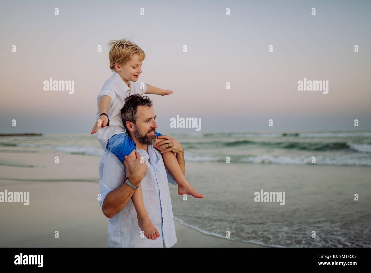 Father with his son enjoying together time at sea Stock Photo - Alamy