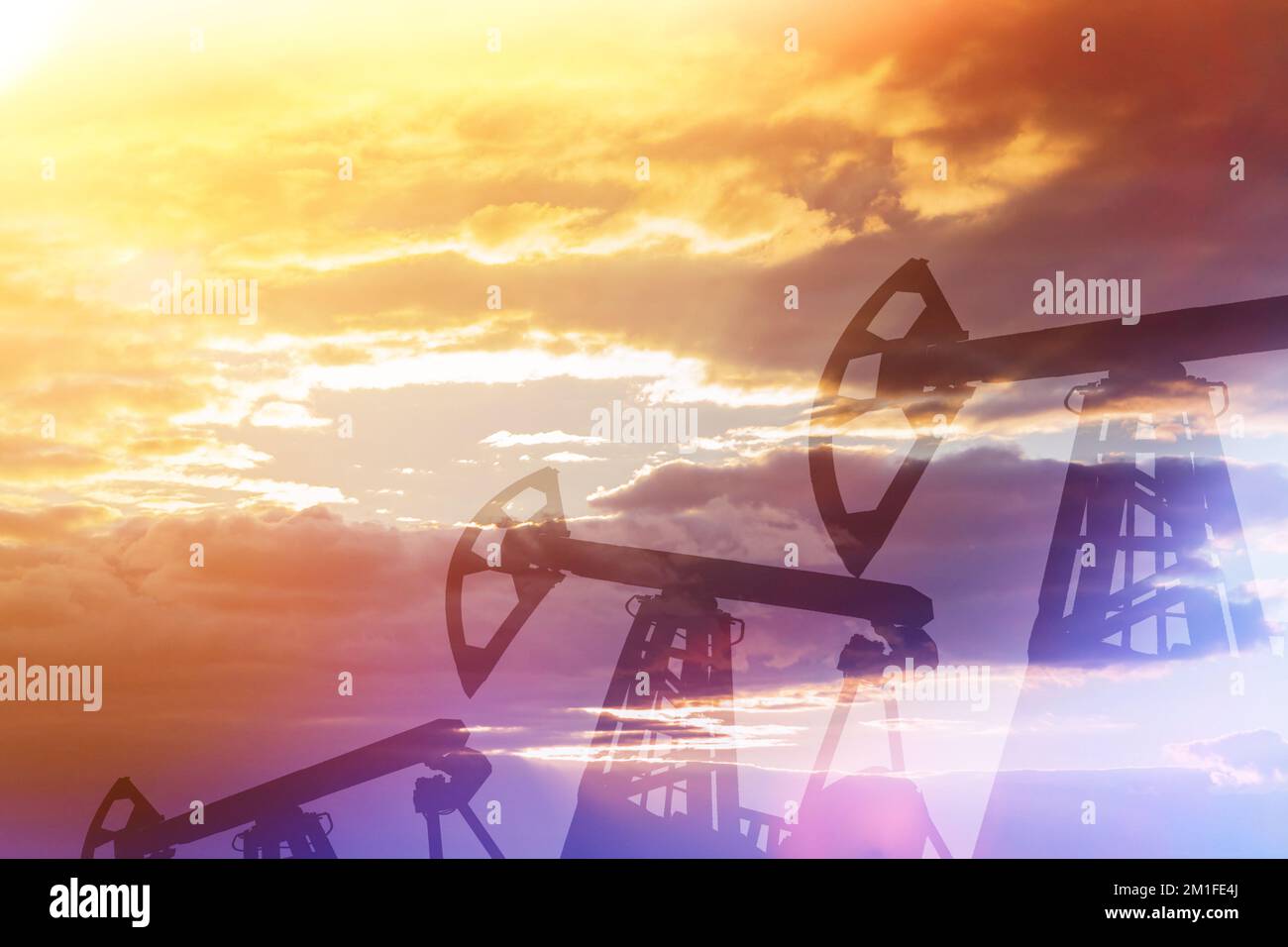 Oil production against backdrop of sunset. Rigs. Oilfield Stock Photo ...