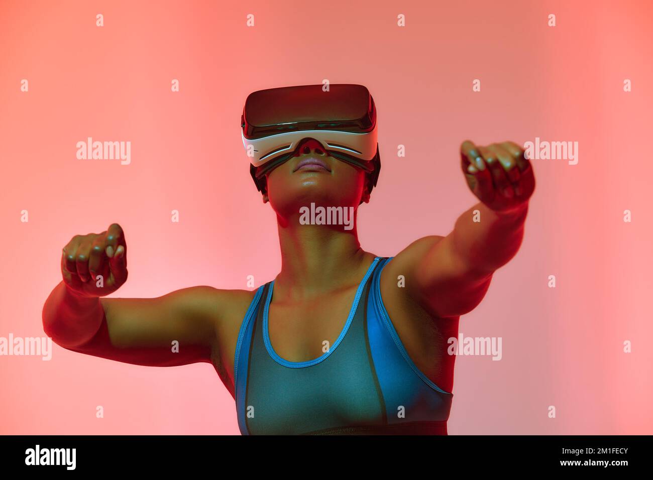 Happy young black lady in VR glasses exploring cyberspace, touching ...