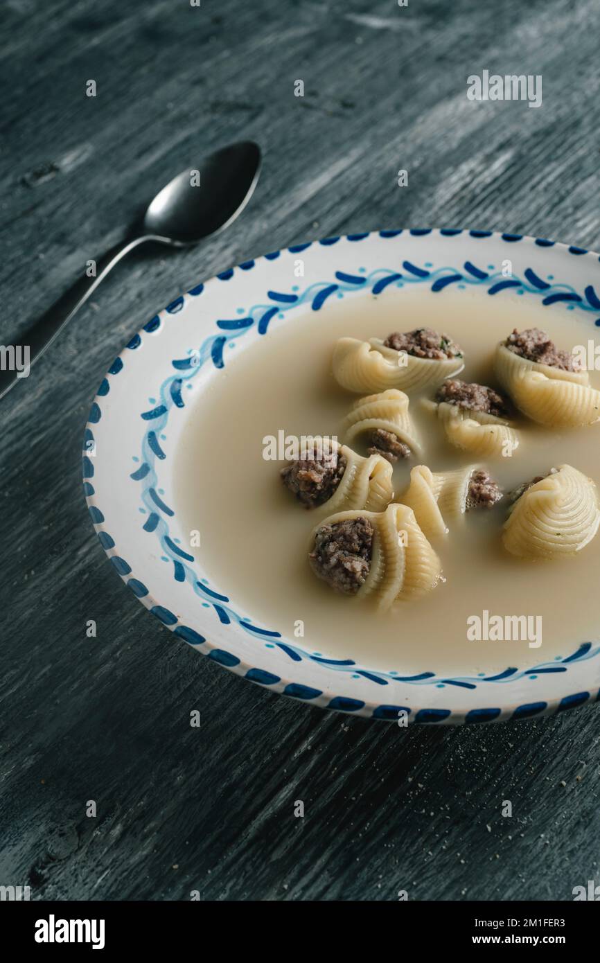 closeup of a vintage white ceramic plate with some escudella de Nadal ...