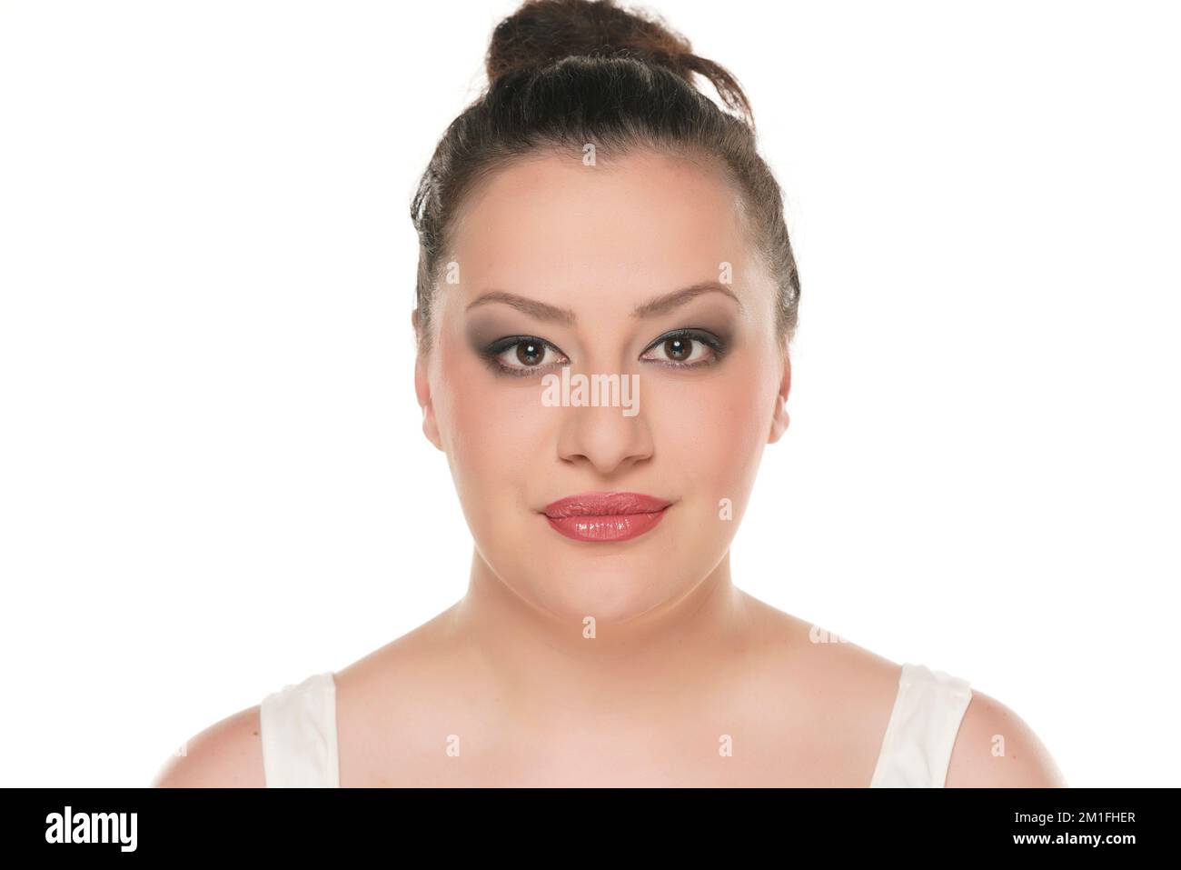 Portrait of a young chubby woman with makeup on a white studio ...