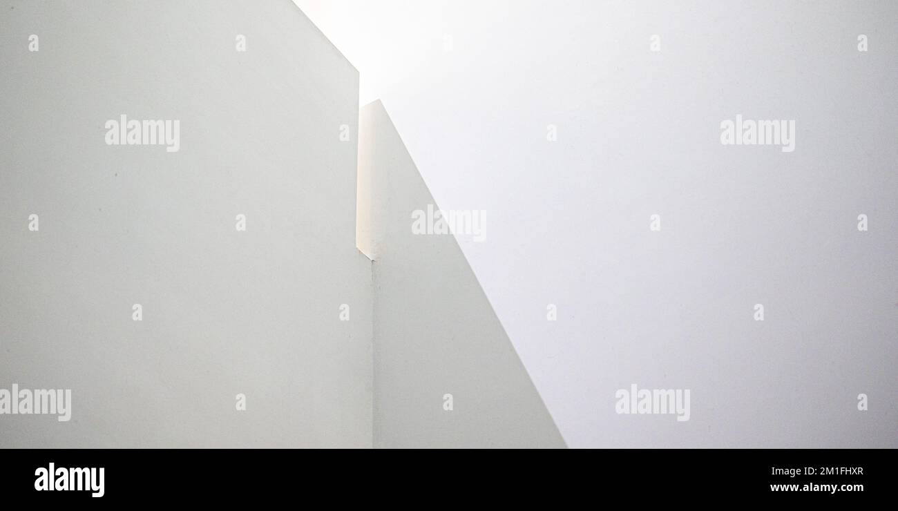 An interior shot of a bright white corner of an indoor place for ...