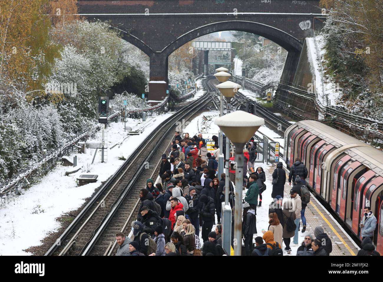 London, UK. 12th Dec, 2022. Commuters wait at the platform for a ...