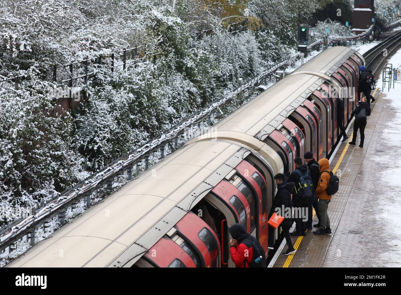 London, UK. 12th Dec, 2022. Commuters get in the train at North Acton ...