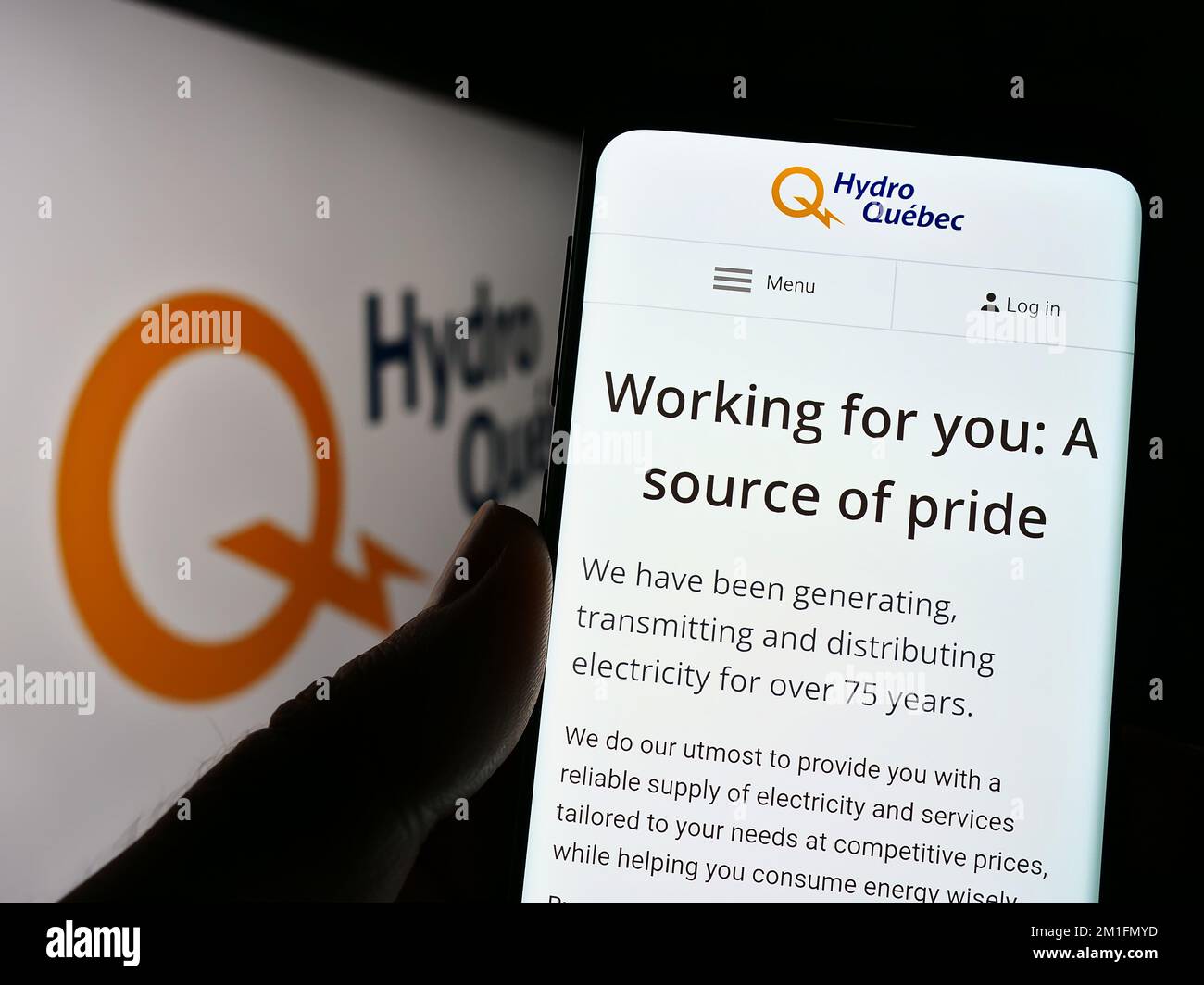 Person holding cellphone with webpage of Canadian utlity company Hydro ...