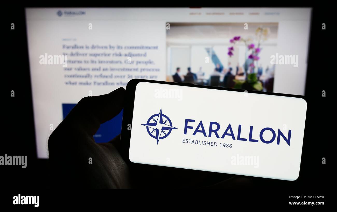 Person holding cellphone with logo of American hedge fund Farallon Capital Management LLC on ...