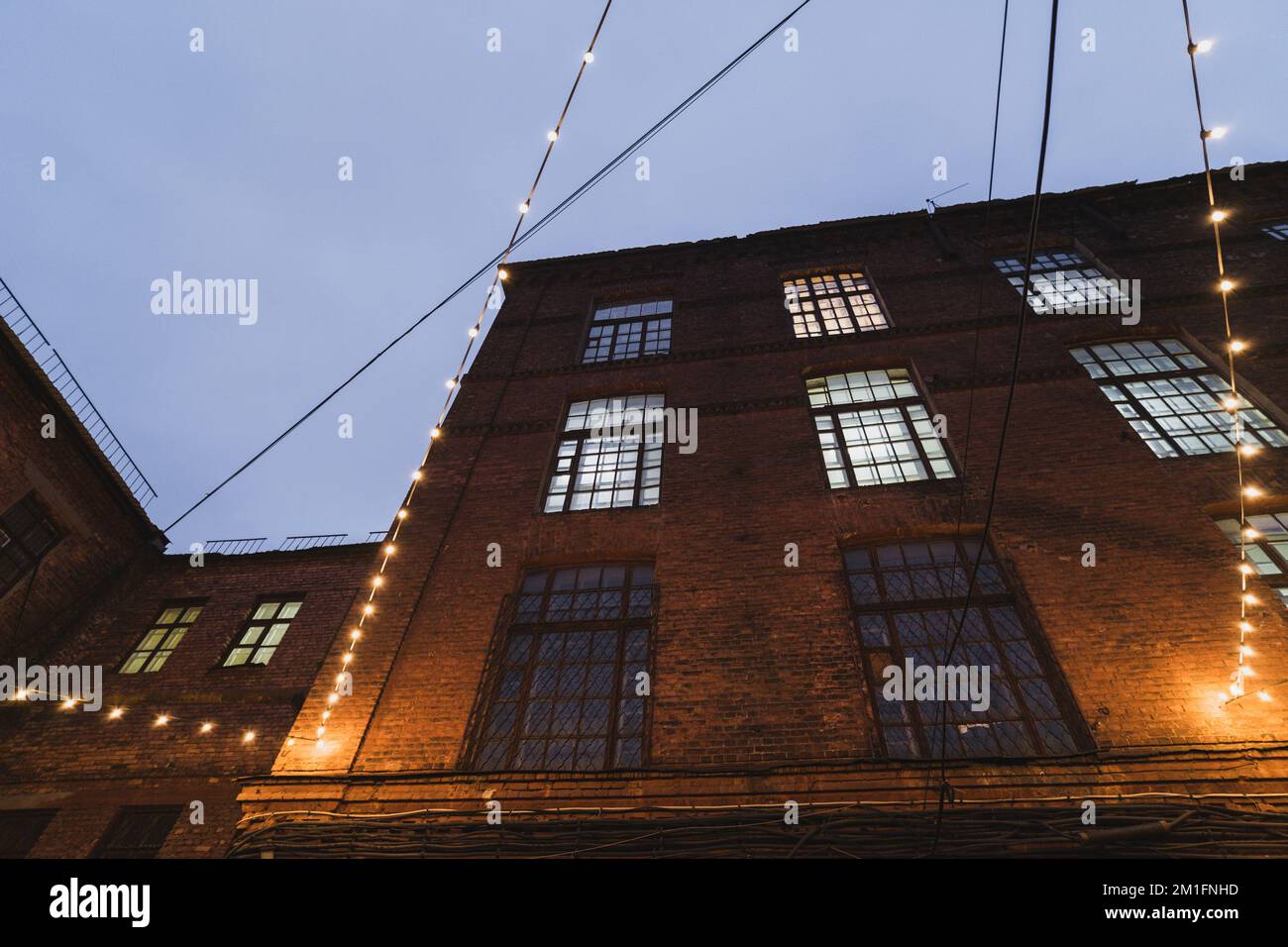 Old brick house illuminated by small lanterns Stock Photo - Alamy