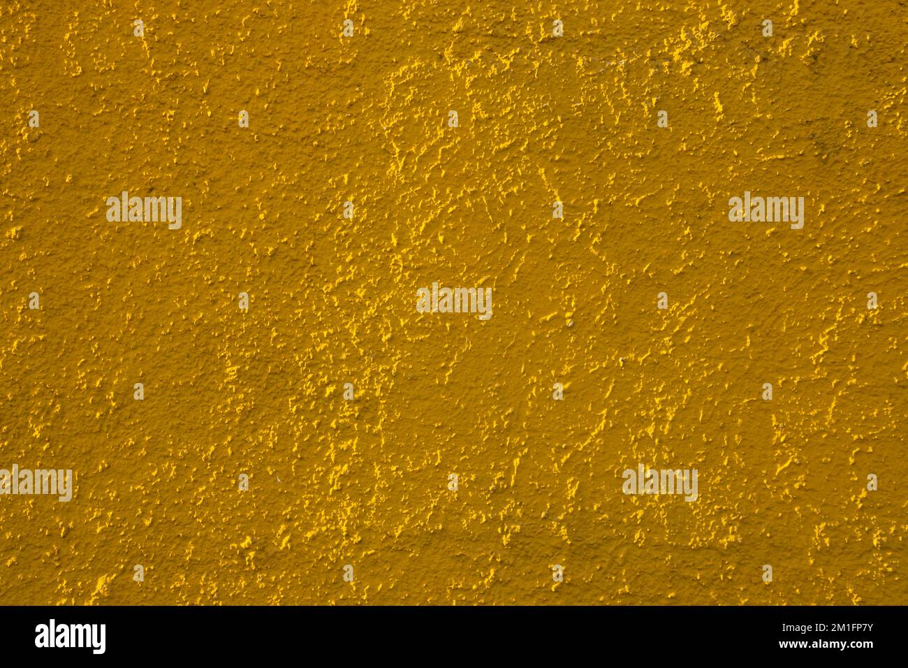 Golden yellow colored abstract wall background with textures of ...