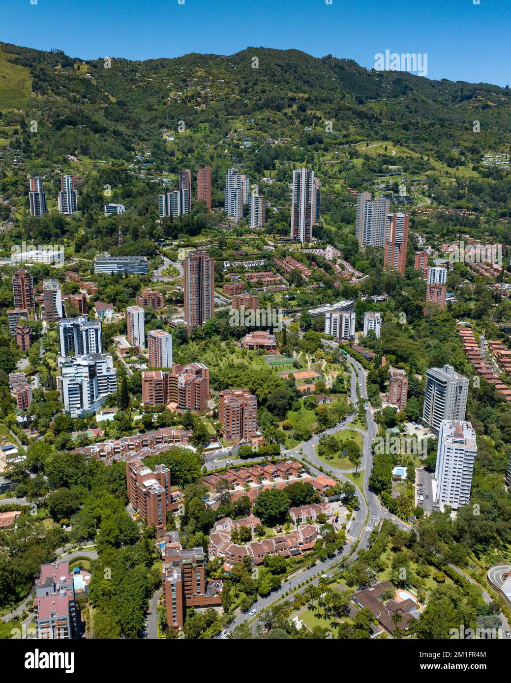 A vertical drone shot of a downtown El Poblado in Medellin with green ...