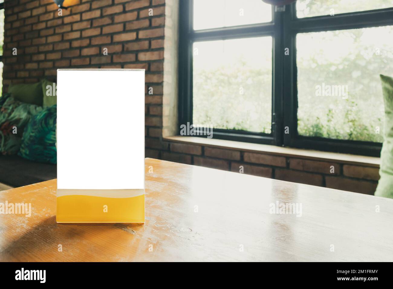 Mockup empty white label menu frame on table with cafe restaurant ...
