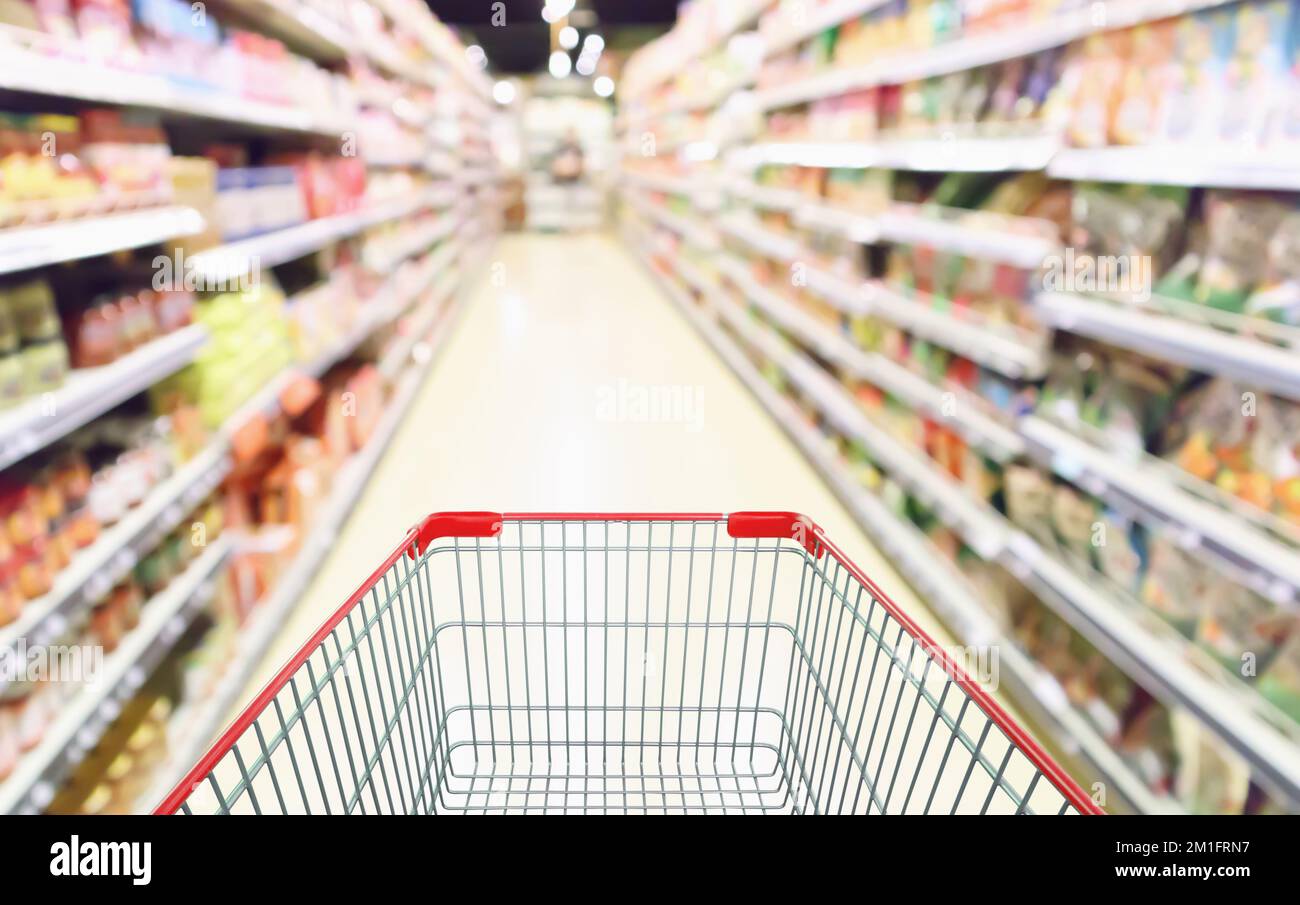 Abstract blur supermarket aisle with can food and snack product on ...