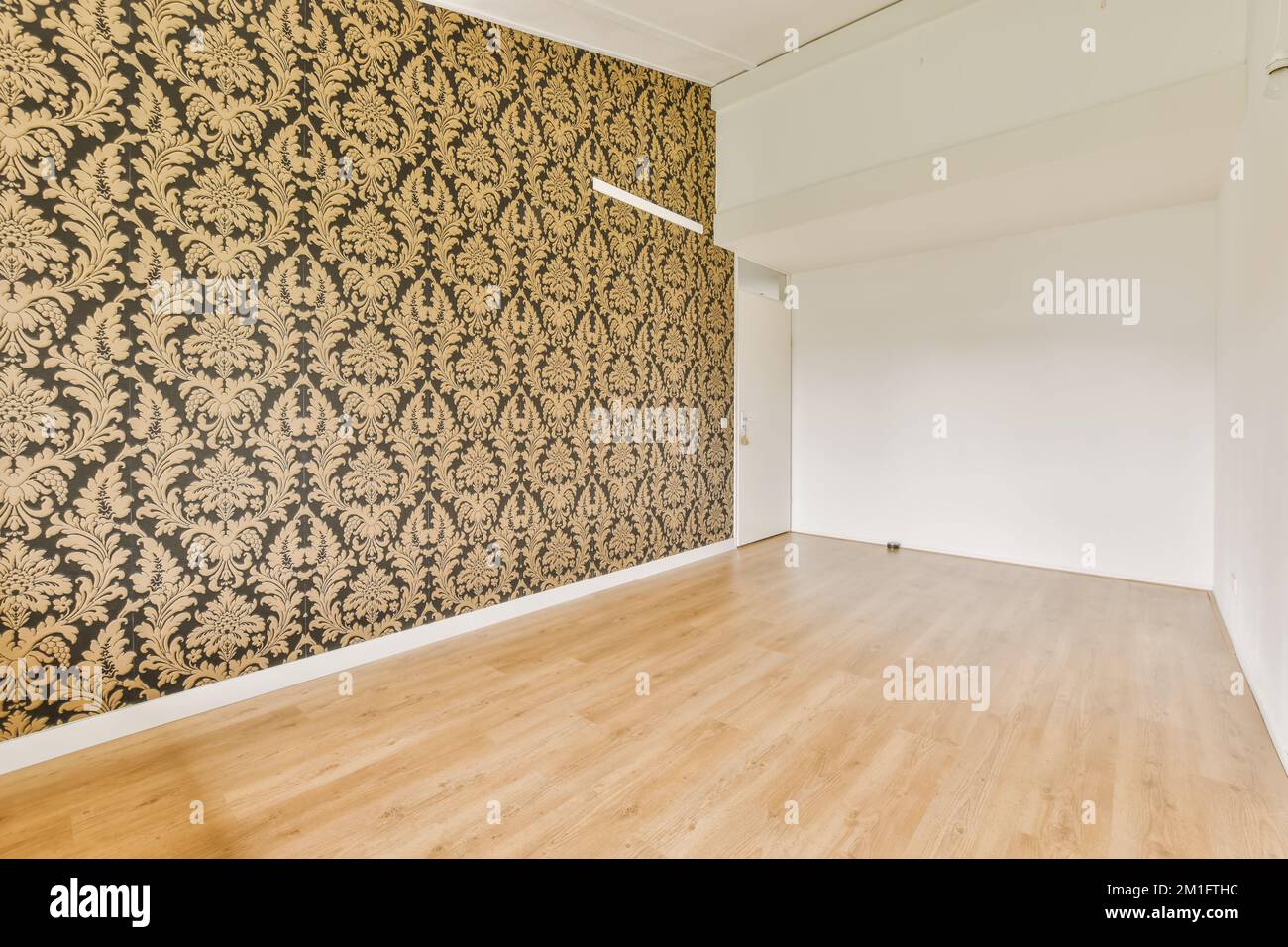 an empty room with wallpapers on the walls and wood flooring in place ...