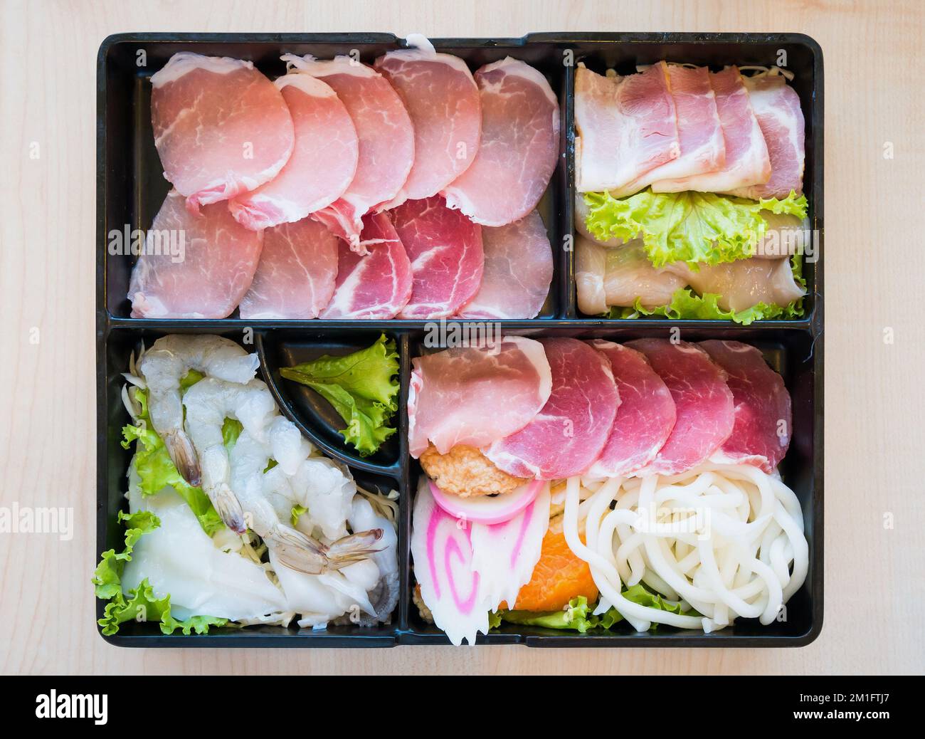 Pork belly slice, prawn, noodles and squid slice on plate, for sukoyaki ...