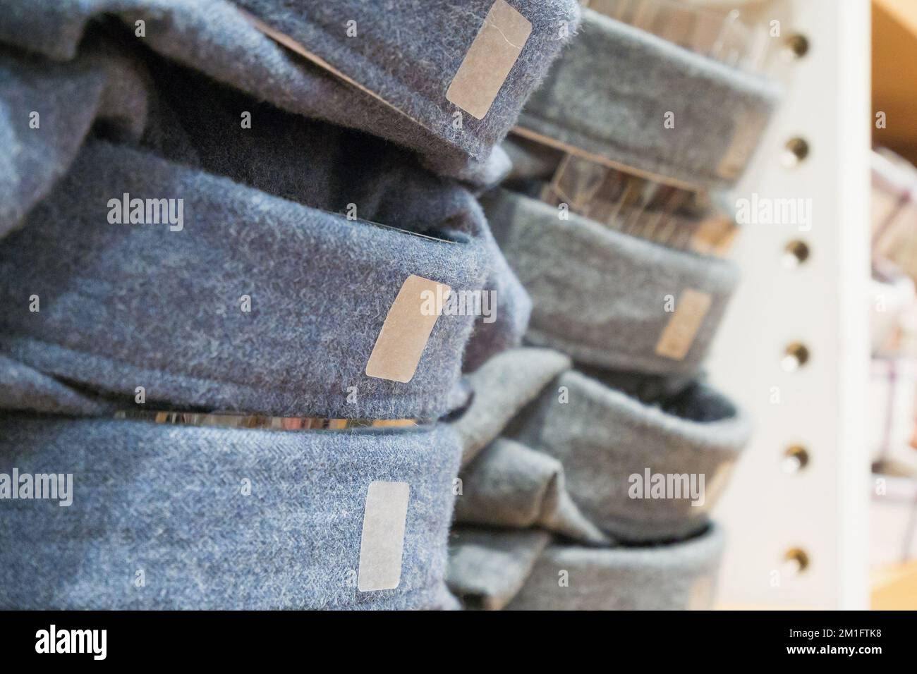 Fashion shirts on shelf in clothing store Stock Photo - Alamy