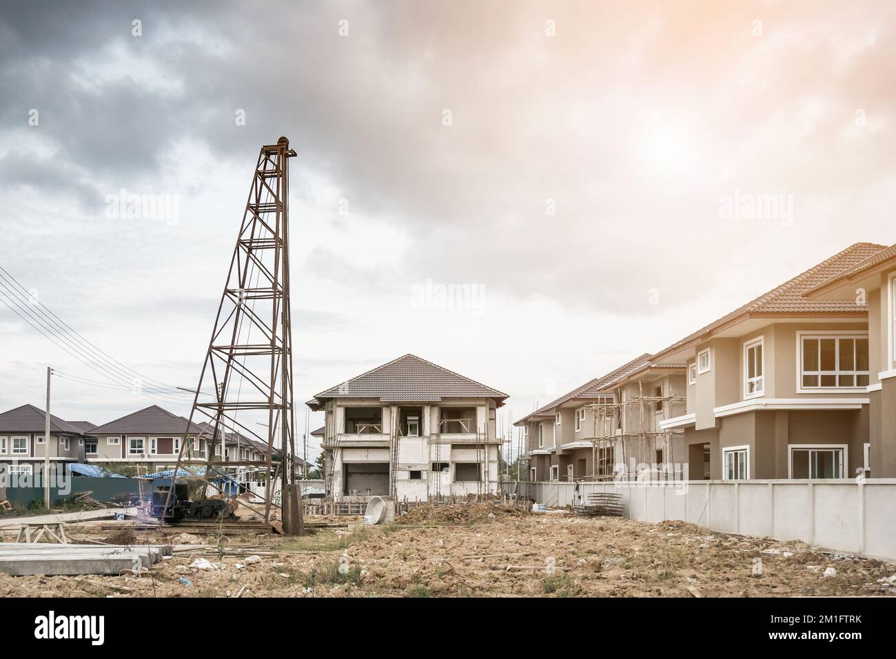 Residential new house building at construction site with clouds and ...