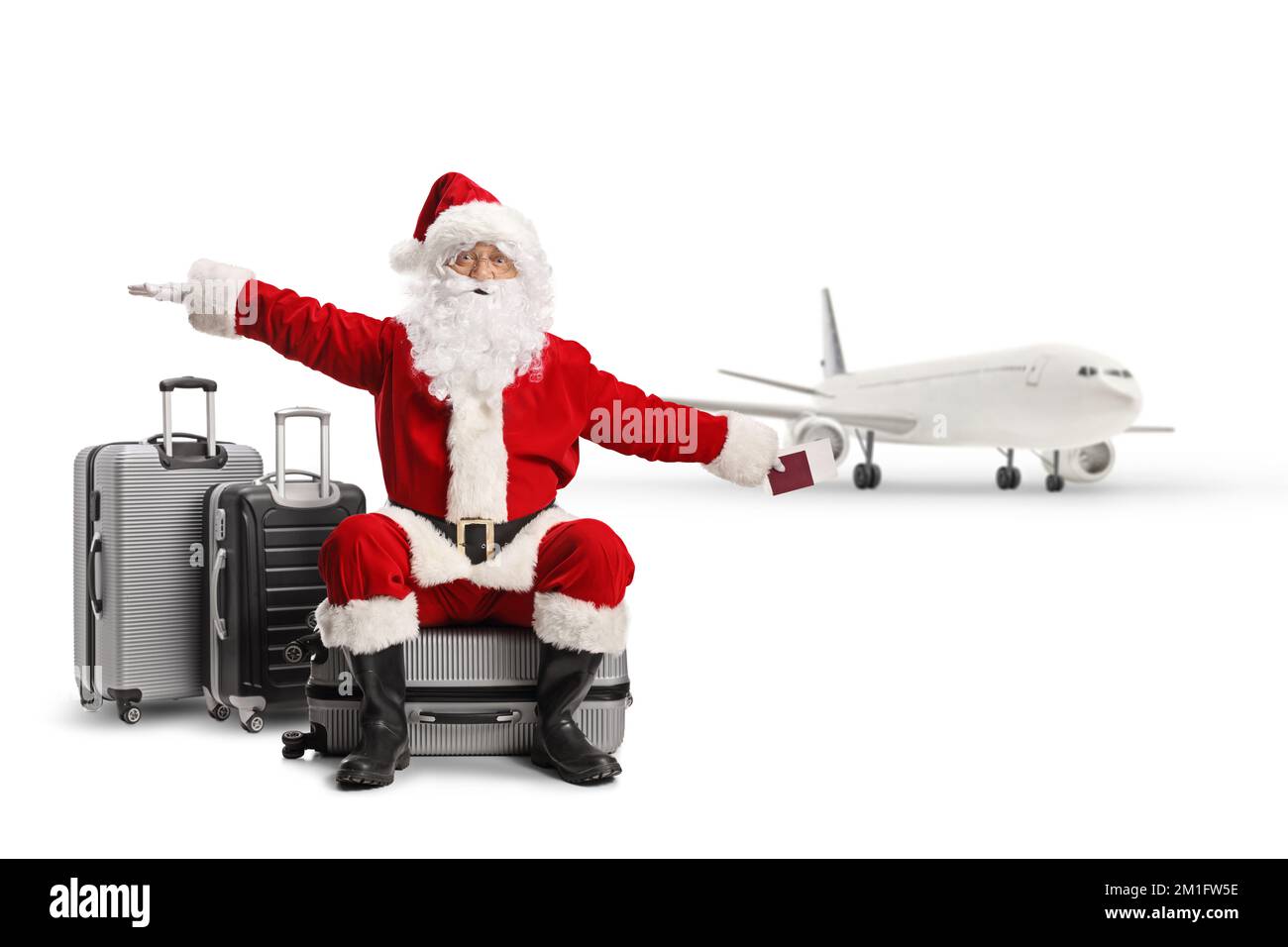 Santa claus sitting on a suitcase in front of an airplane and flying ...