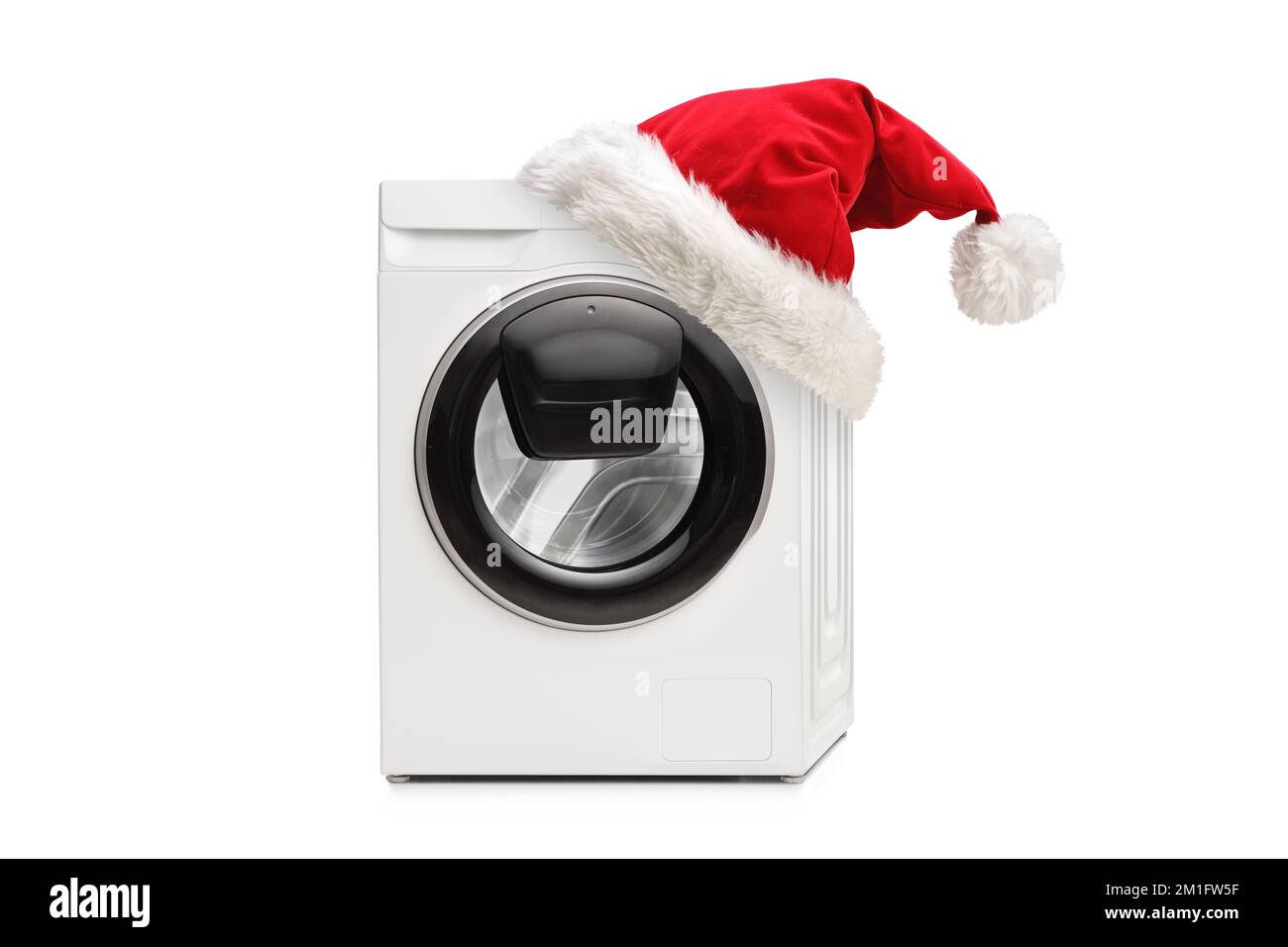 Studio shot of a new washing machine with a santa claus hat isolated on ...