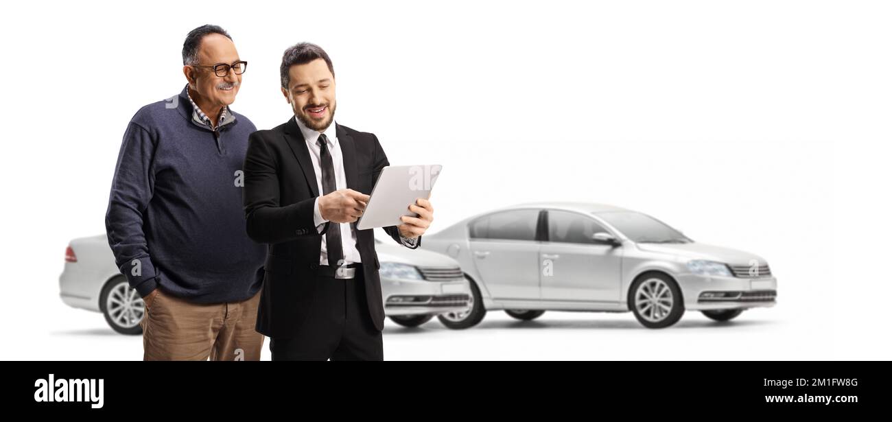 Salesman presenting cars to a mature customer on a digital tablet ...