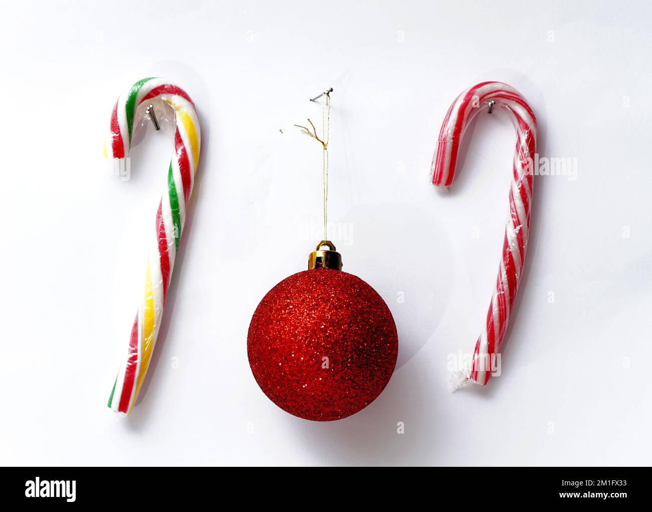 Mint hard candy cane and bauble, on a white background Stock Photo - Alamy