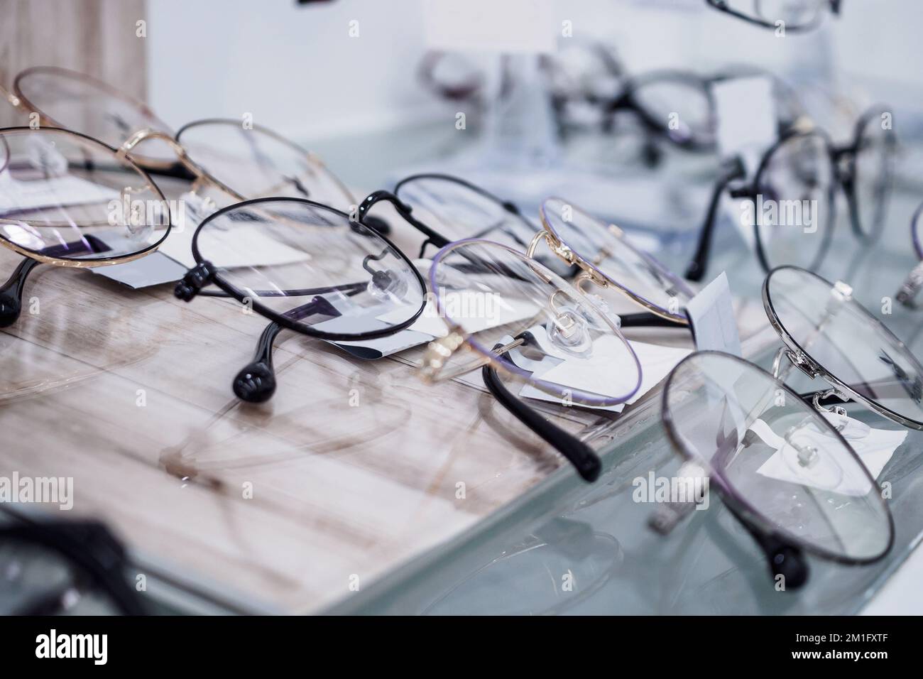 Eye glasses on window display shelves in optics store Stock Photo - Alamy