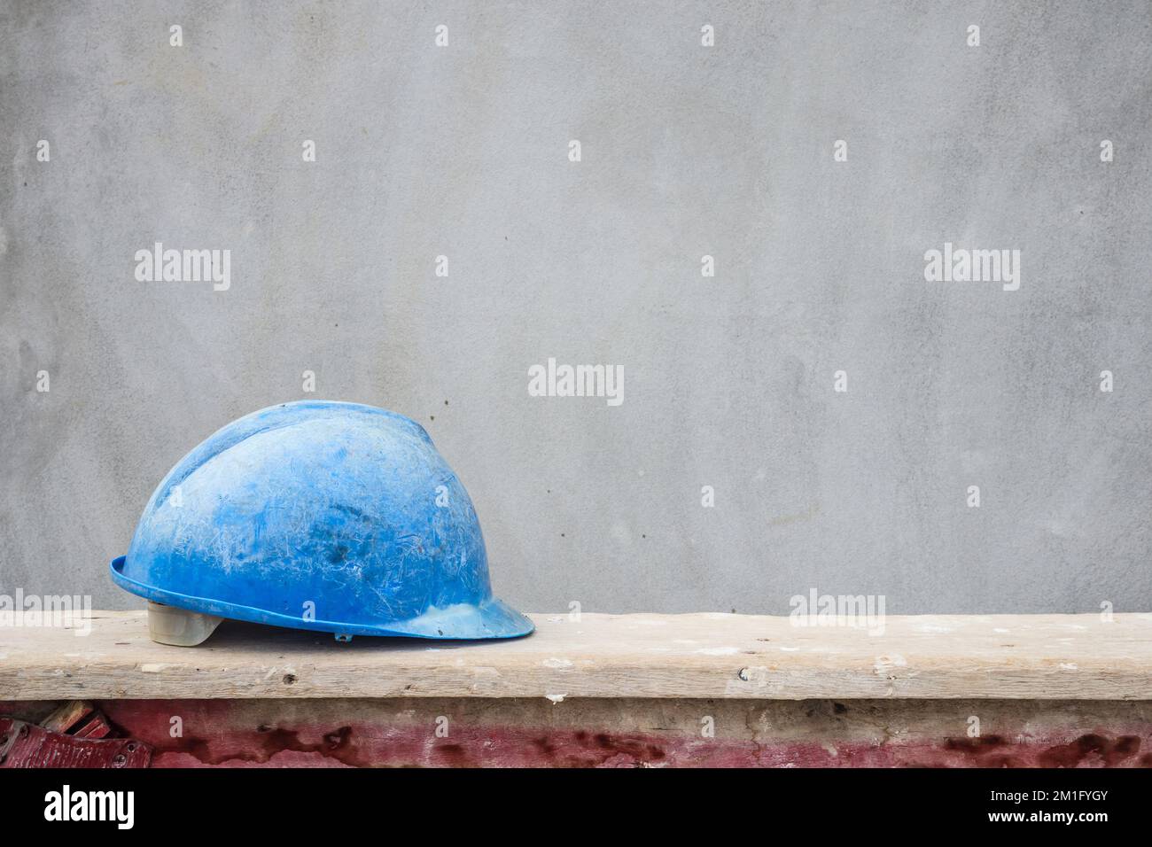 Blue hard hat on house building construction site Stock Photo - Alamy