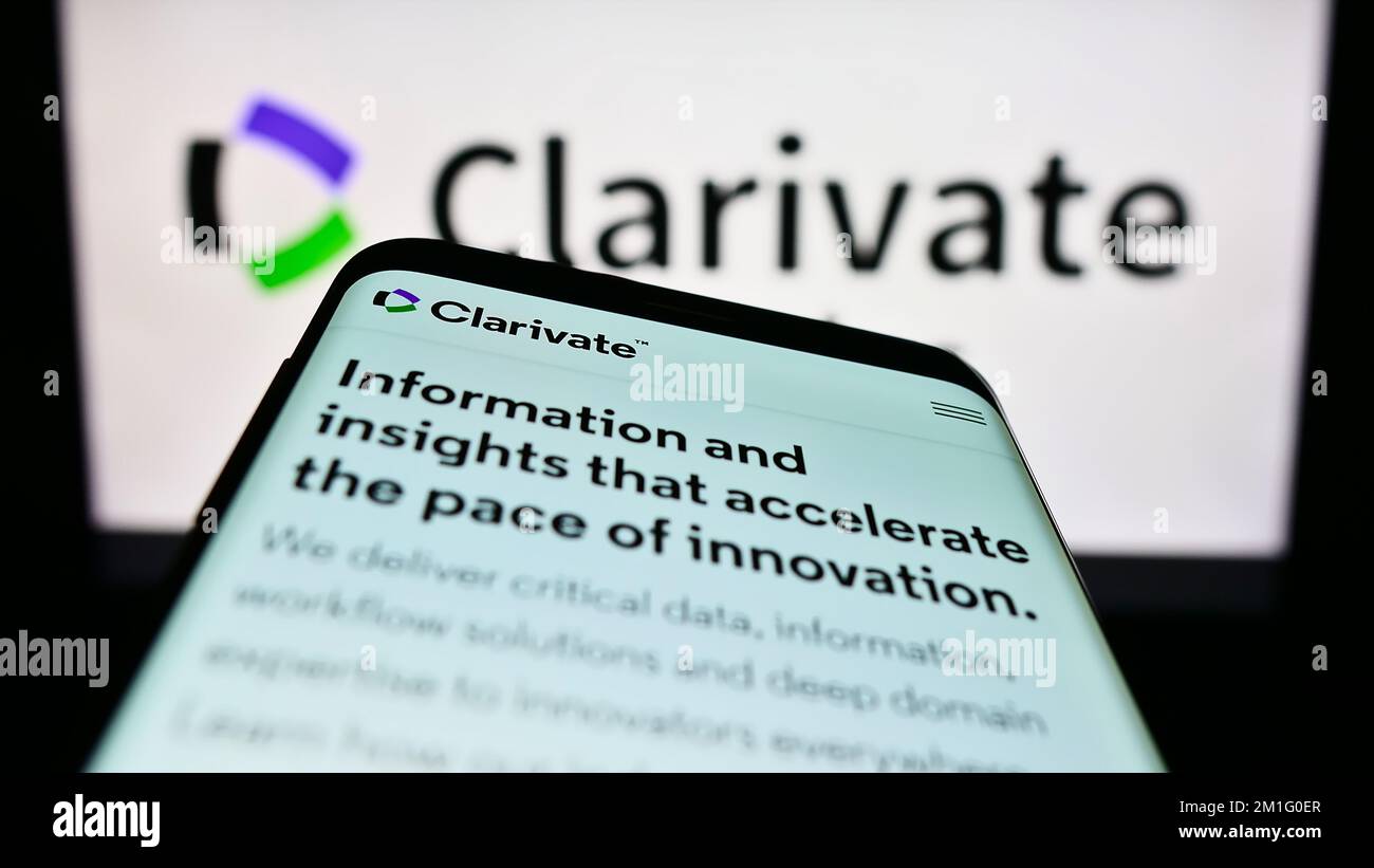 Mobile phone with website of analytics company Clarivate plc on screen ...