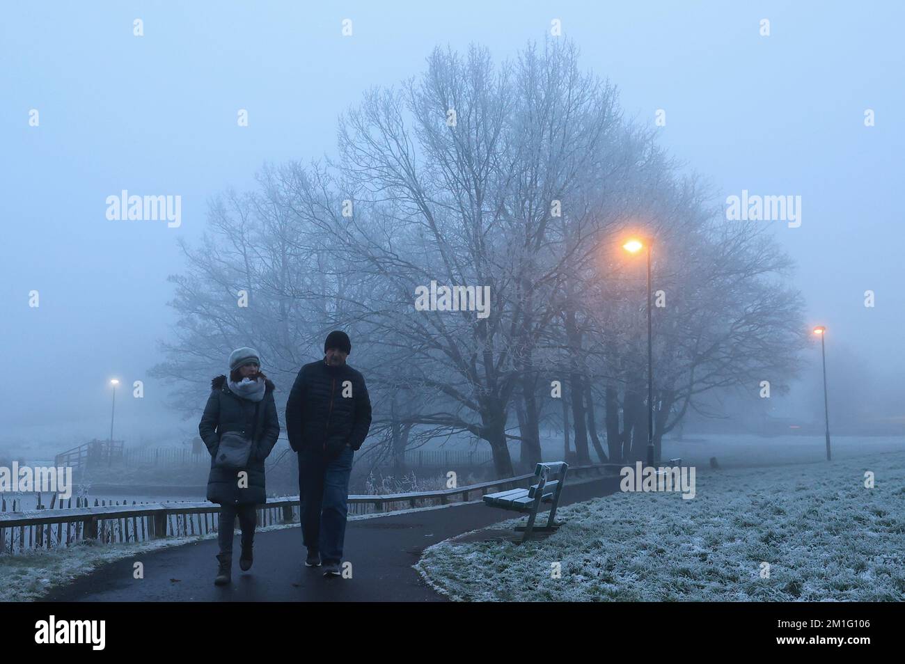 A couple walk in the mist at Dungannon Park, Northen Ireland. Freezing ...