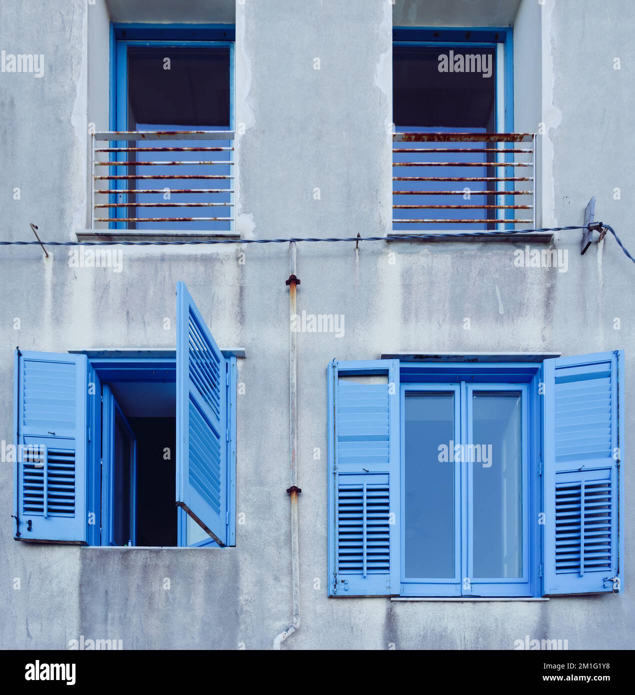 Buildings with blue shutters in Trapani, Sicily Stock Photo - Alamy