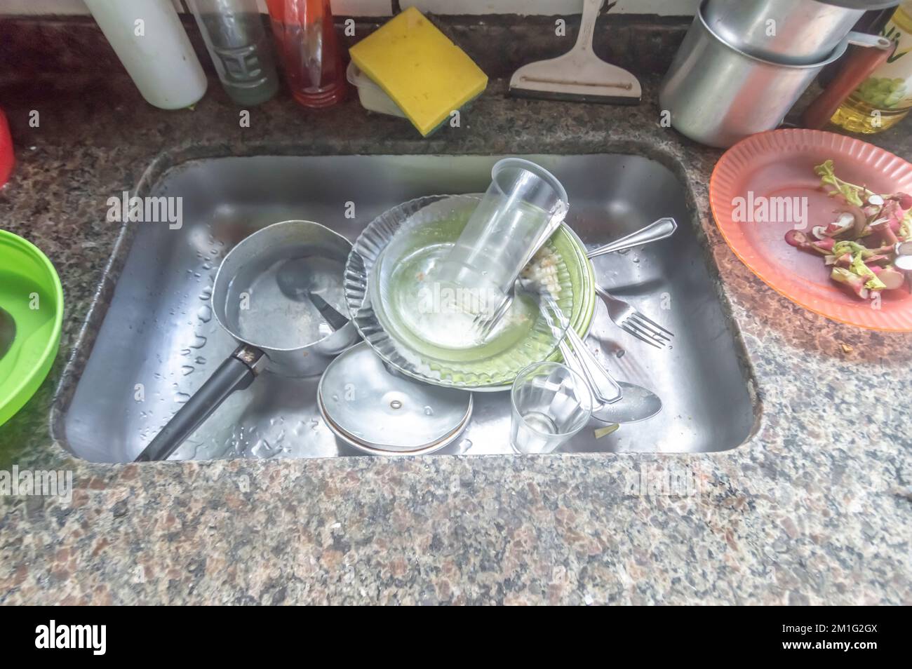 Dirty dishes, dishes, cutlery and dirty pots in a simple home sink,real ...