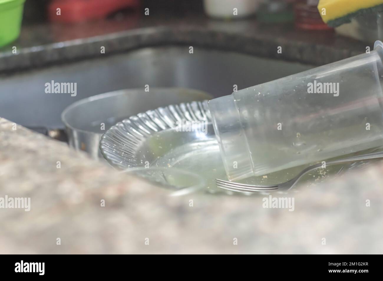 Dirty dishes, dishes, cutlery and dirty pots in a simple home sink,real ...