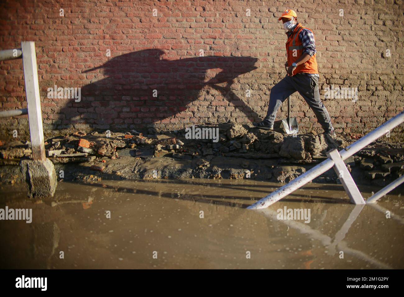 Kathmandu Nepal. 12th Dec, 2022. A construction worker crosses a ...