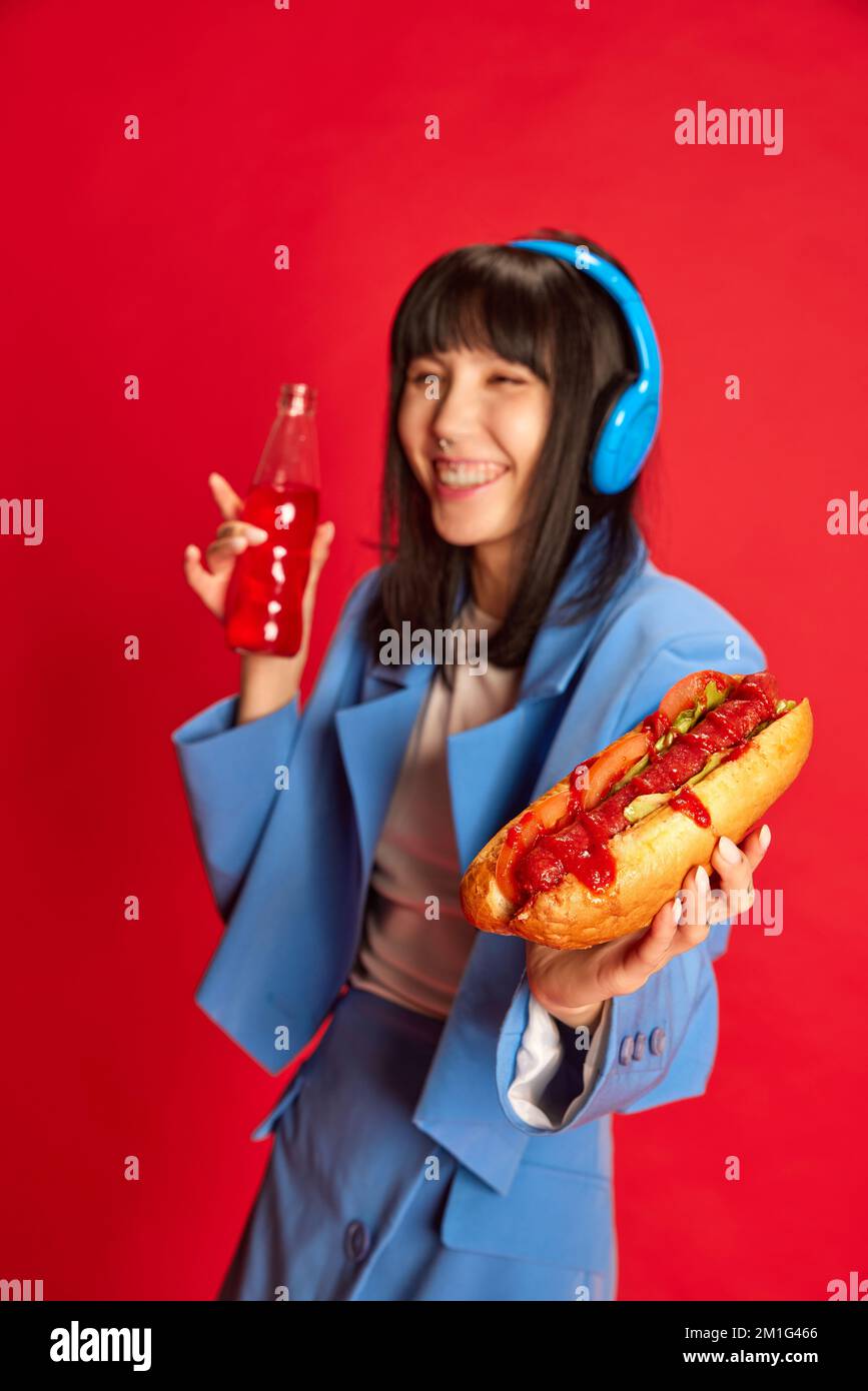Unfocused portrait of young girl in stylish blue costume posing with ...