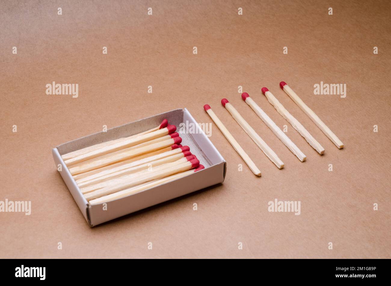 Set of new unlit matchsticks in a matchbox orderly aligned on natural ...