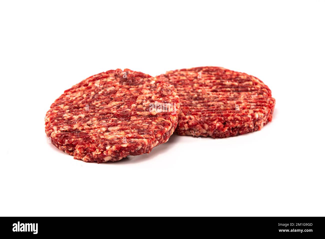 The pieces of juicy raw red patty meat isolated on a white background ...