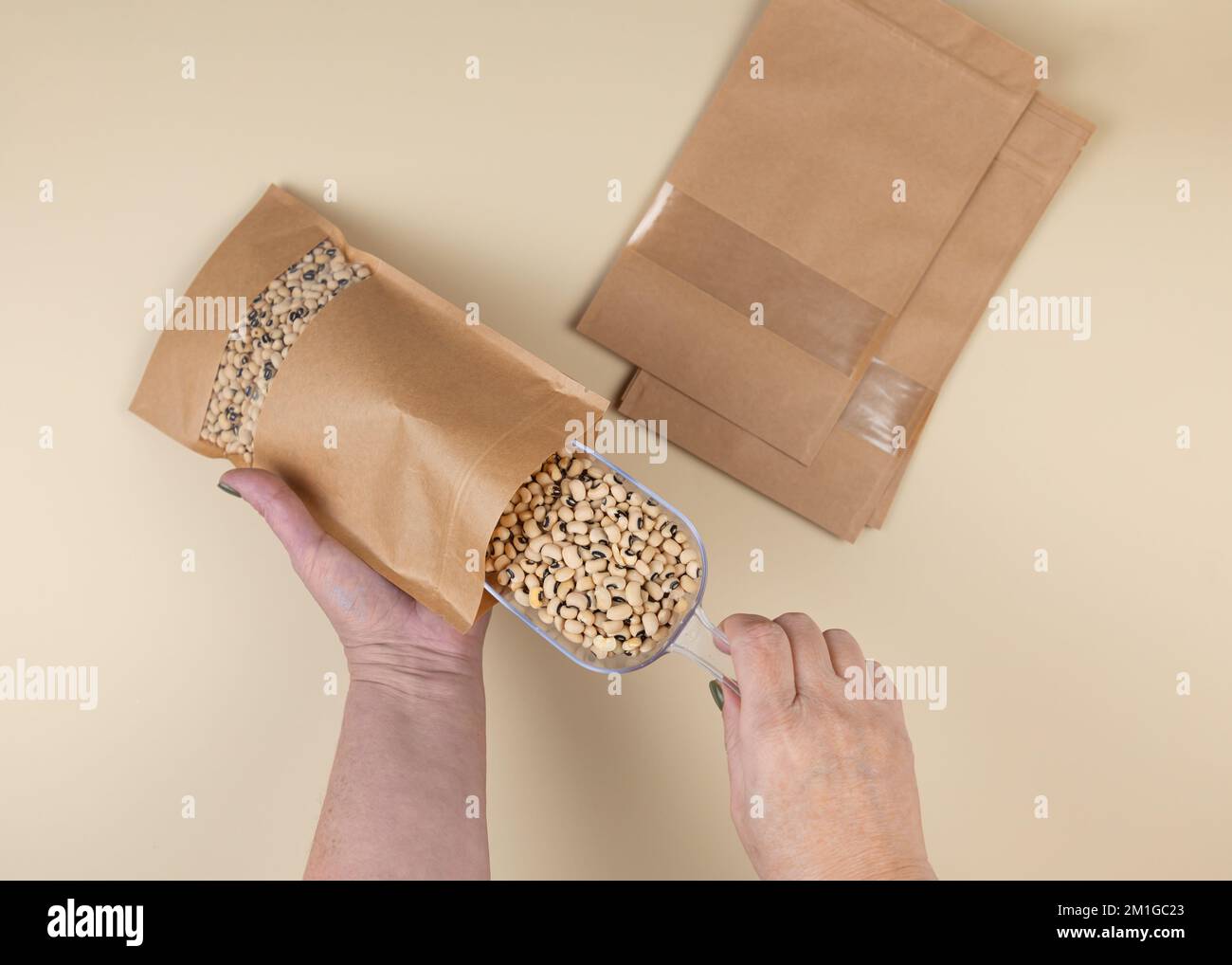 Brown kraft paper doypack bags with black-eyed peas on a yellow ...