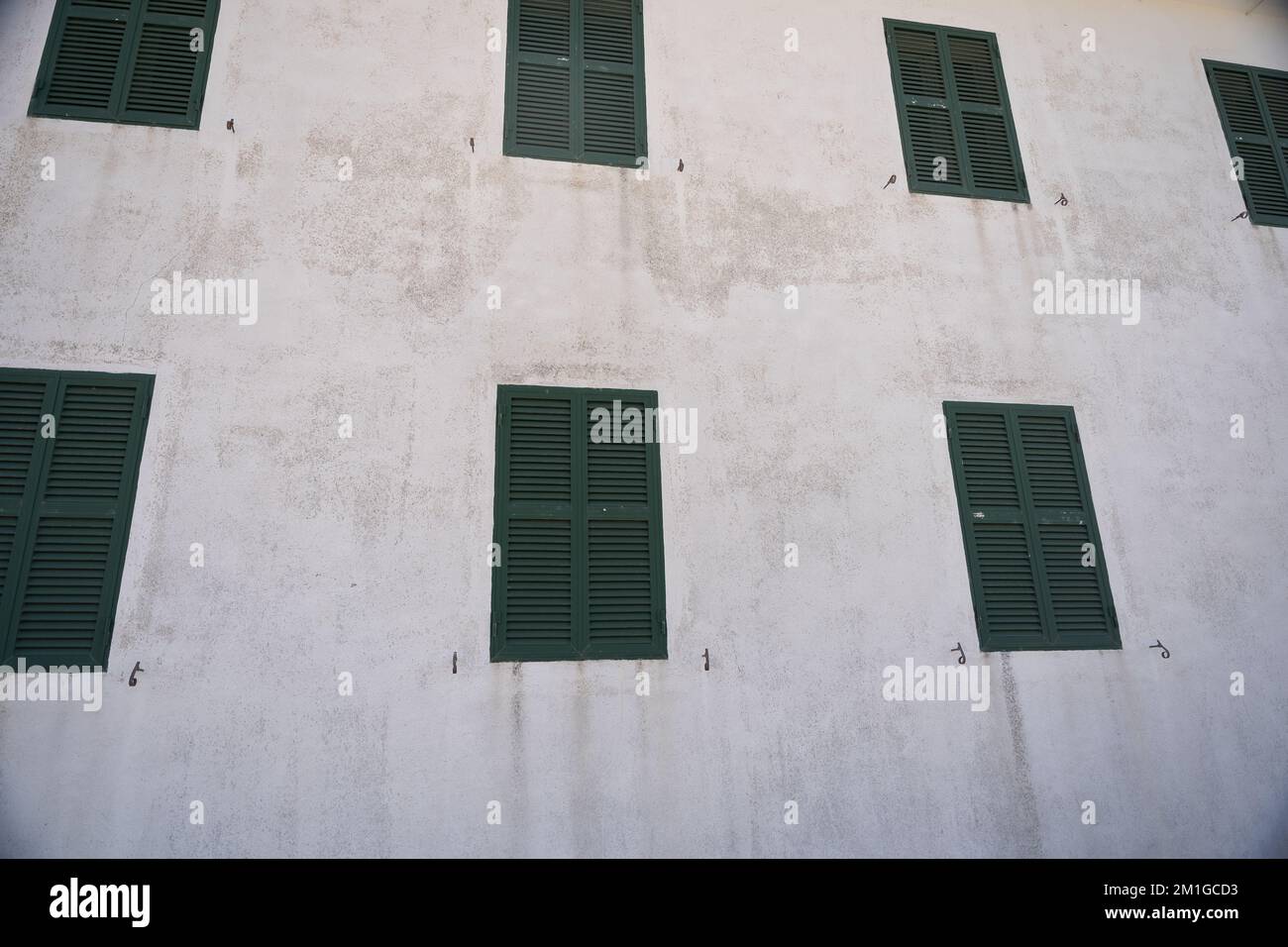 The exterior of a building with closed windows Stock Photo - Alamy