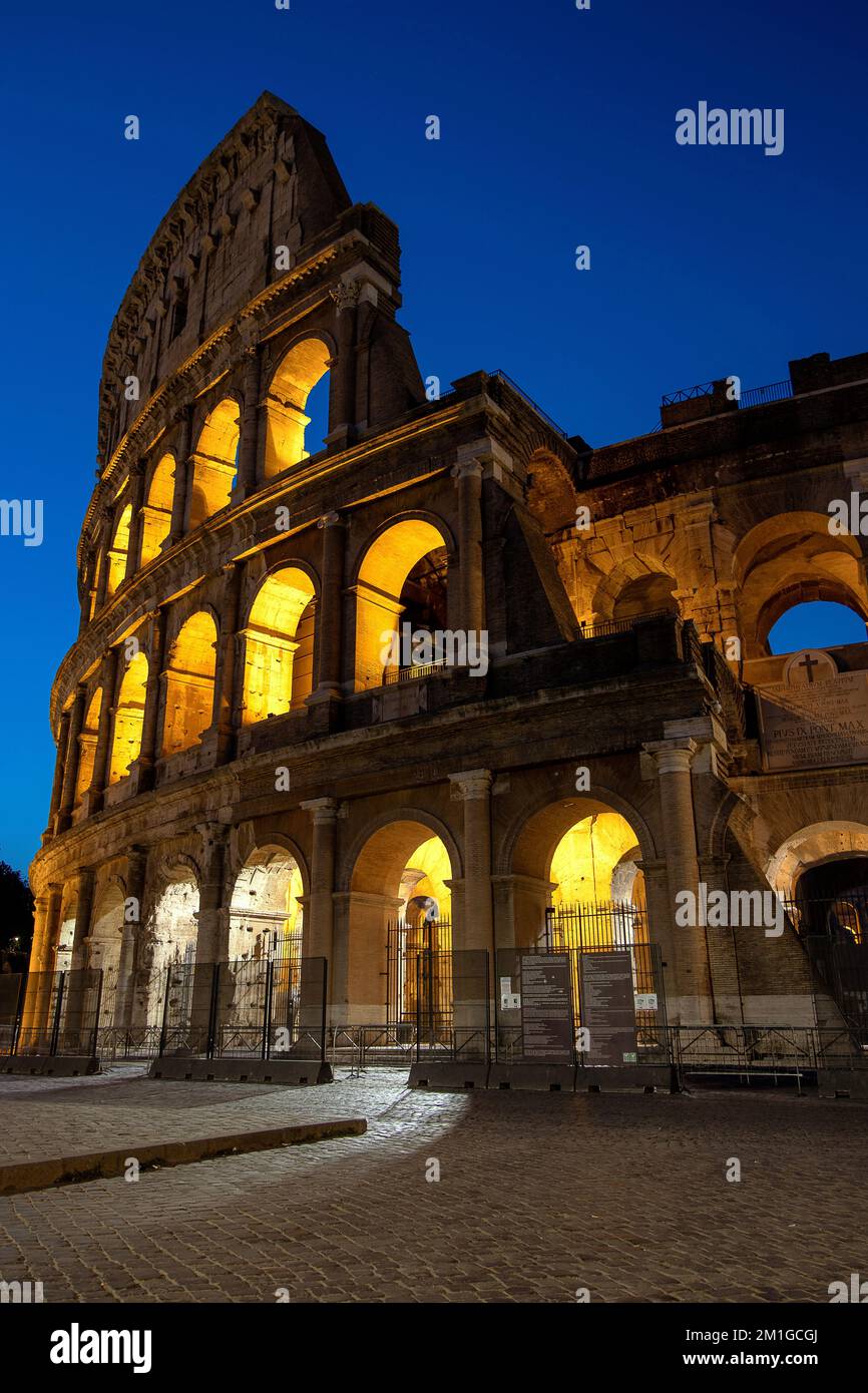 A vertical shot of the illuminated Colosseum at night in Rome, Italy ...