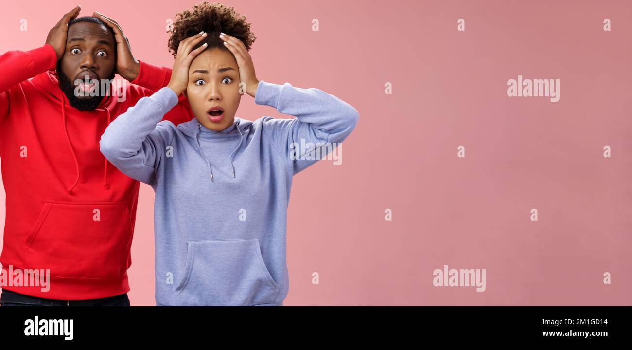 Shocked worried african american couple man woman holding hands head ...