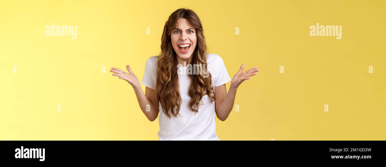 Disappointed angry furious woman shrugging hands sideways dismay ...