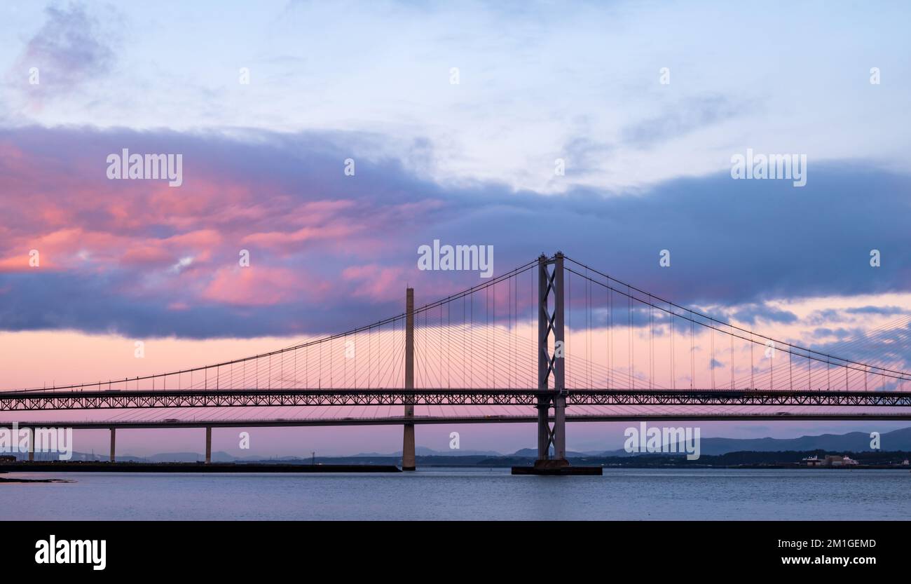 A pink sunrise over Queensferry Crossing and Forth Road bridges at dawn ...