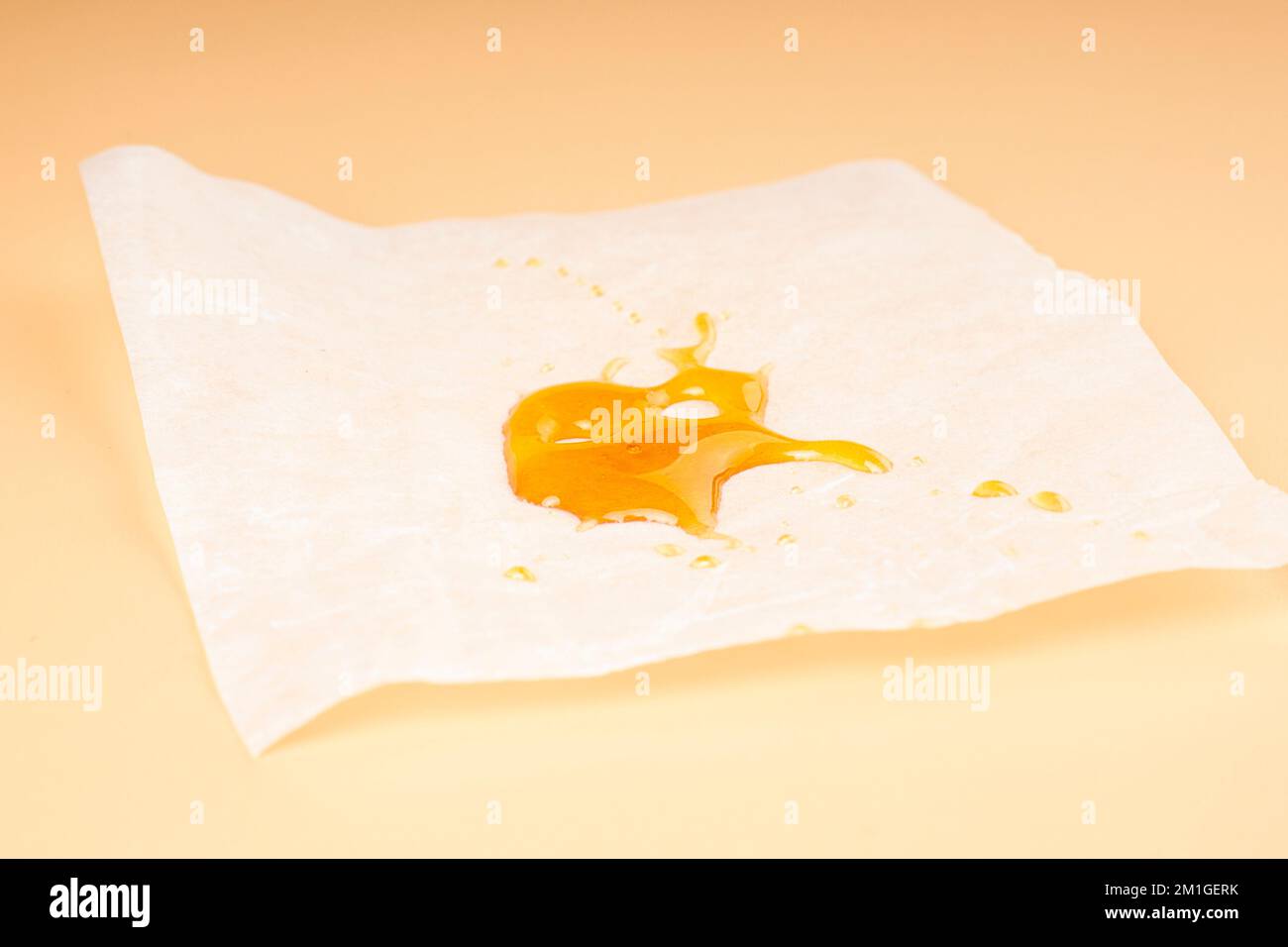 marijuana resin concentrate, amber cannabis wax in paper Stock Photo ...