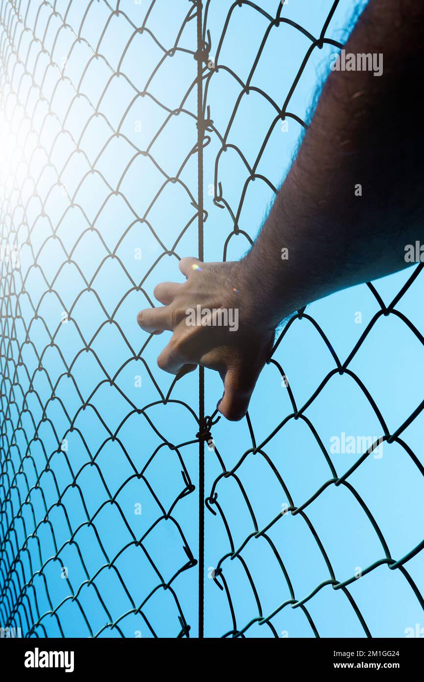 Grabbing the fence hi-res stock photography and images - Alamy