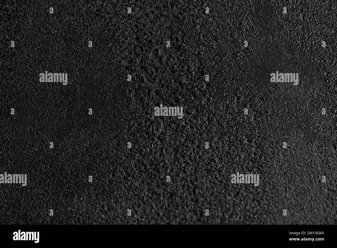 Close up of dark grey, grainy surface for modern, unusual background ...