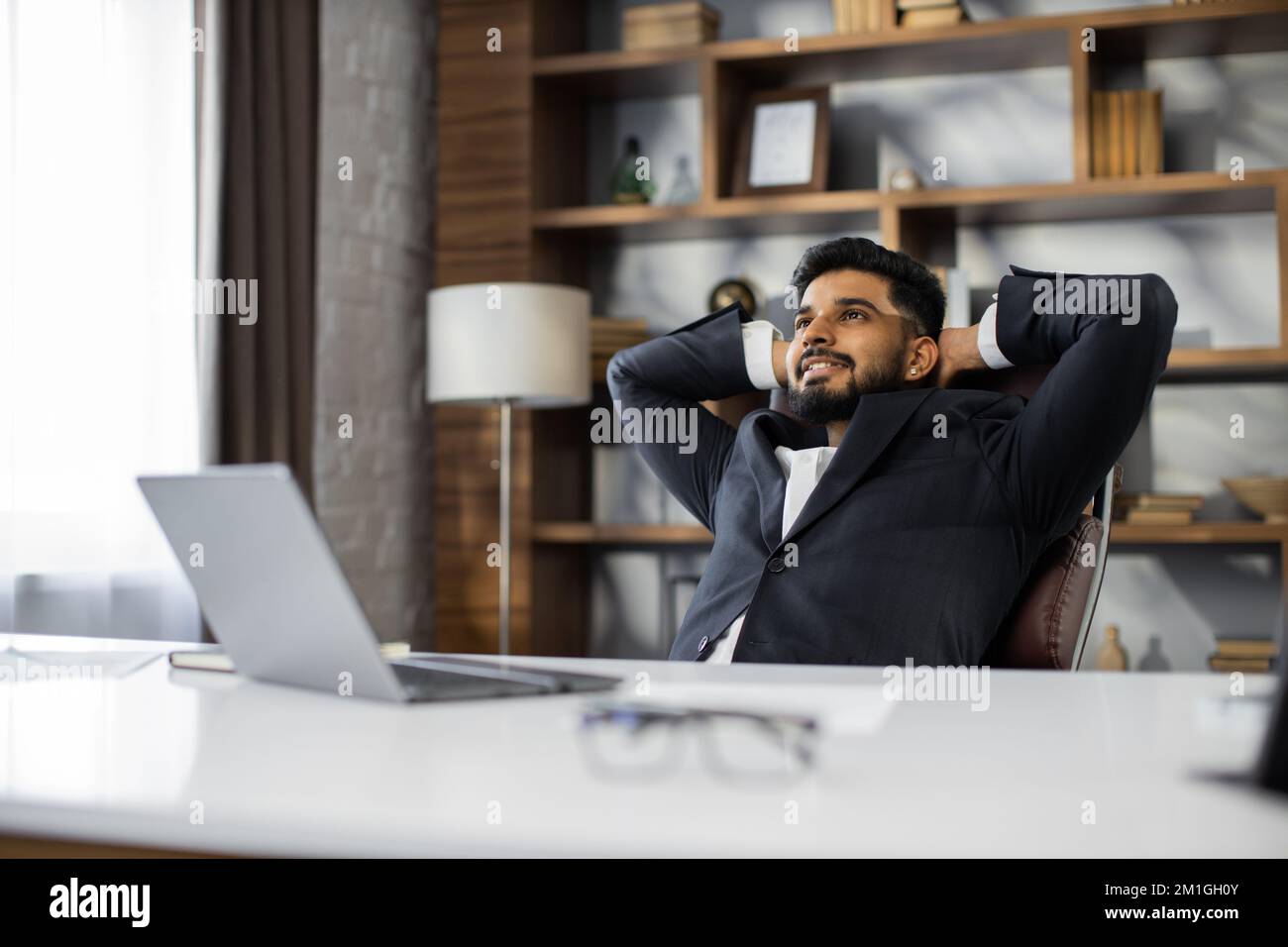 Confident man in glasses sitting relax at home office workplace take ...