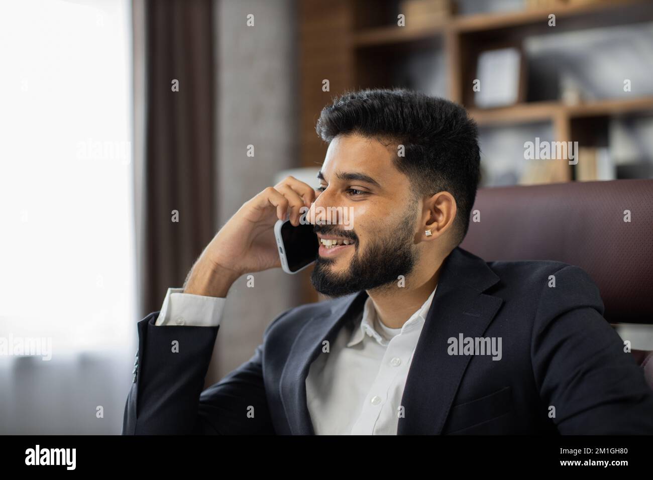 Close up portrait of cheerful bearded male boss in business suit ...