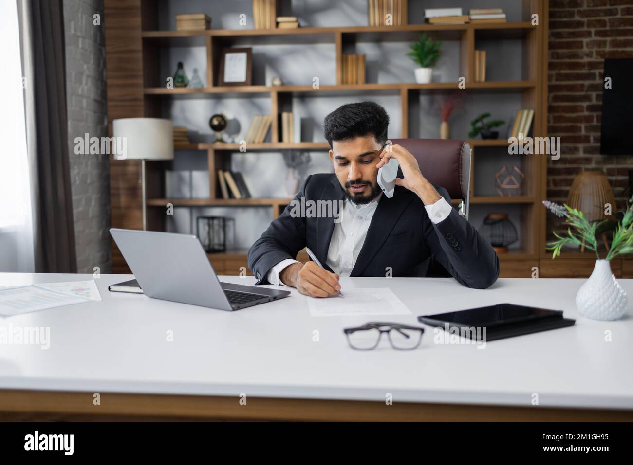 Successful young entrepreneur with attentive and concentrated look ...