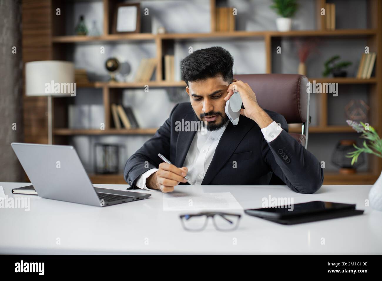 Successful young entrepreneur with attentive and concentrated look ...