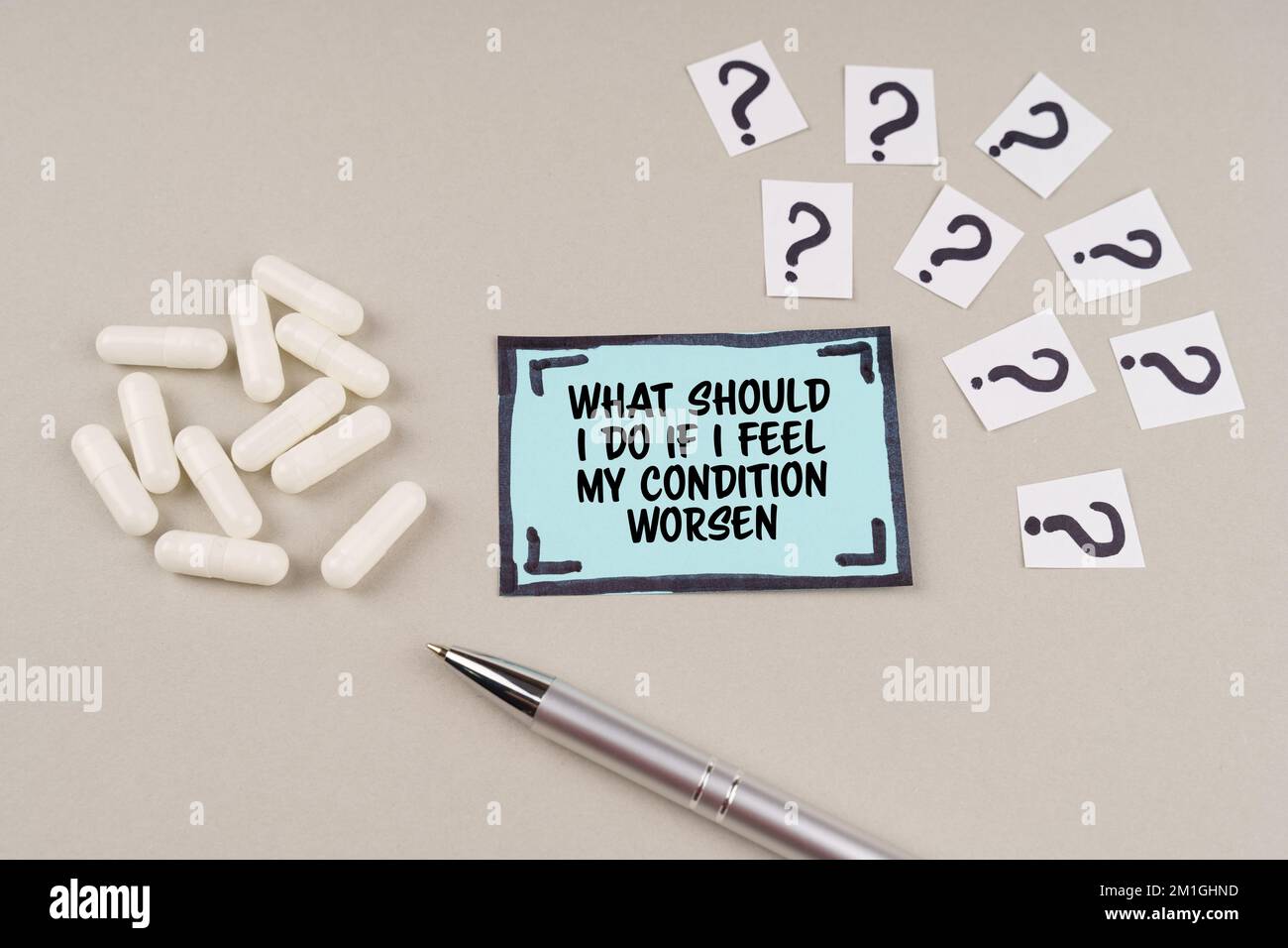 Medical concept. On a gray surface there are question marks and a blue ...