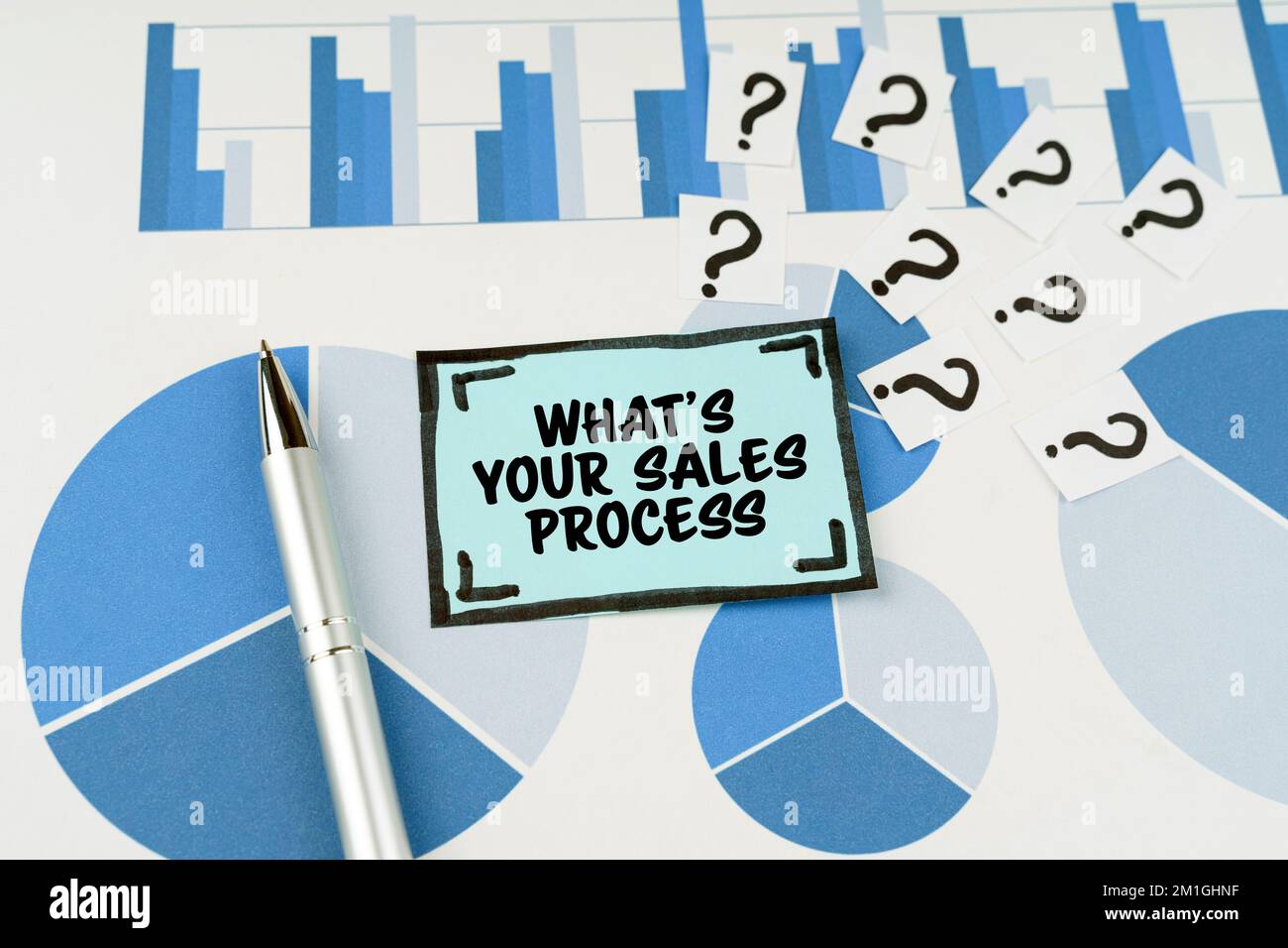 business question concept. On the blue diagrams lies a pen, questions ...
